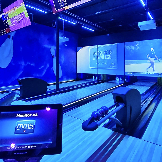 Sleek bowling lanes bathed in cool blue light invite players to knock down pins while looking impossibly stylish doing it.