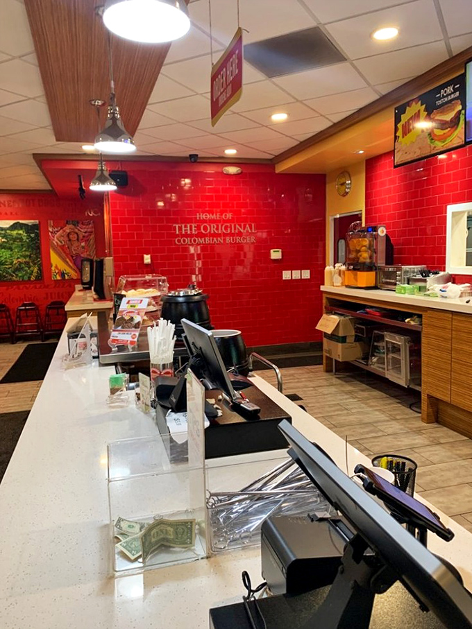 Where culinary magic happens daily&mdash;the pristine counter and vibrant red walls setting the stage for Colombian street food theater.