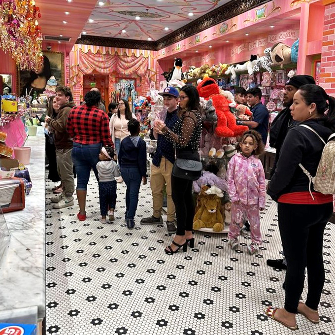 Families line up for their sweet fix, each face showing that universal "about to get ice cream" expression of pure anticipation.