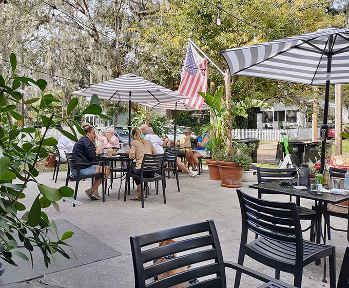 The outdoor patio creates an urban oasis – where locals gather under striped umbrellas to enjoy Florida sunshine and exceptional sandwiches.