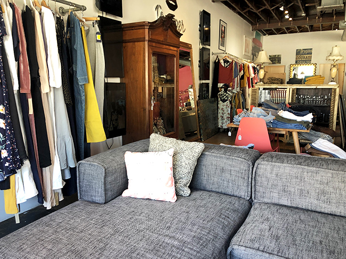 A contemporary gray sofa provides the perfect resting spot amid racks of carefully curated clothing &ndash; because serious treasure hunting requires strategic breaks.