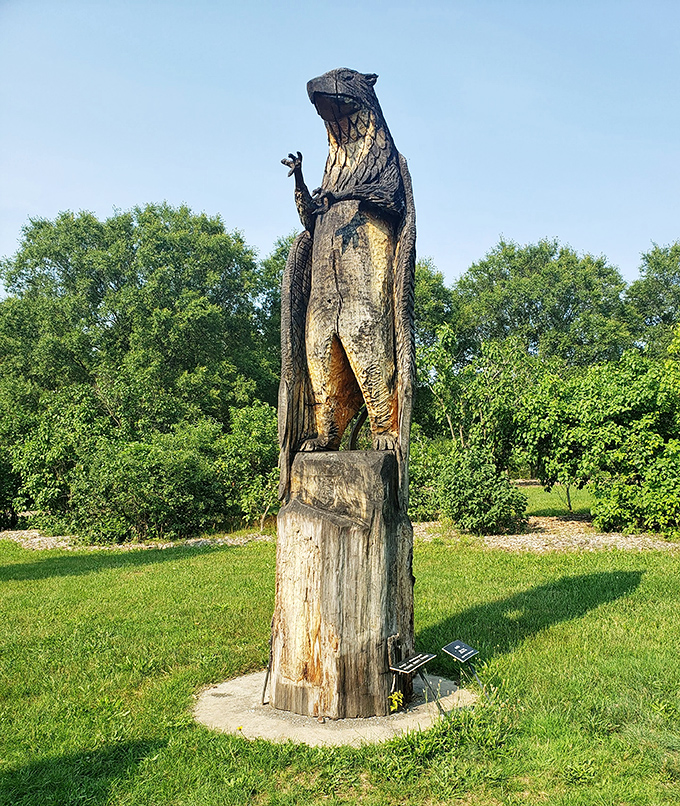 A majestic griffin stands sentinel on its wooden perch, the mythical creature's eagle head and lion body rendered in impressive detail.