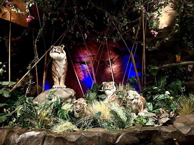 Lifelike tigers lounge in fabricated habitats, frozen mid-prowl as diners enjoy their meals, blissfully safe from becoming the next course.