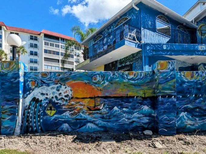 Dramatic waves crash along the lower portion of the house, creating a sense of movement that makes the static structure feel alive with energy.