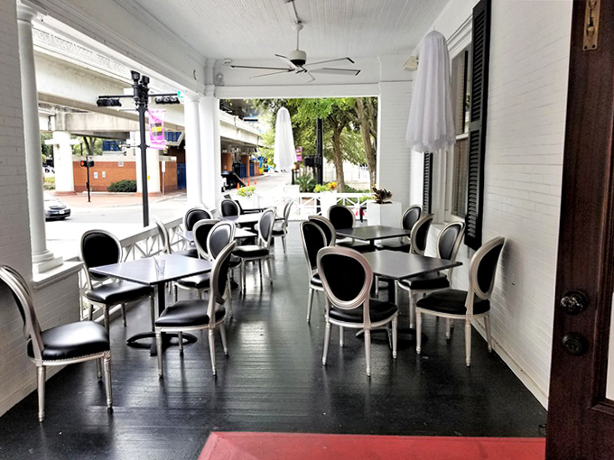 Black and white elegance meets outdoor charm on this wrap-around porch. Perfect for savoring treats in the Florida sunshine.