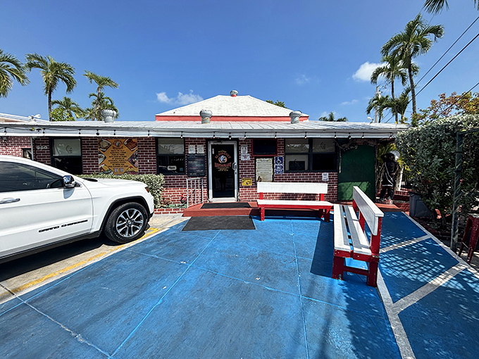 The bright blue outdoor seating area welcomes hungry visitors with cheerful red benches &ndash; a perfect spot to anticipate the feast that awaits.
