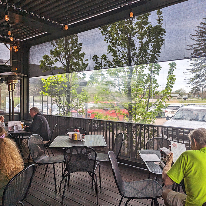 The screened patio offers al fresco dining with a side of people-watching &ndash; summer evenings at their finest.