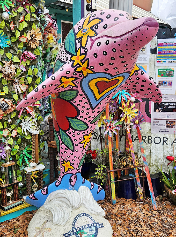 This isn't just any dolphin – it's a pink celebration of hearts, stars and whimsy that seems to leap joyfully from the garden floor.