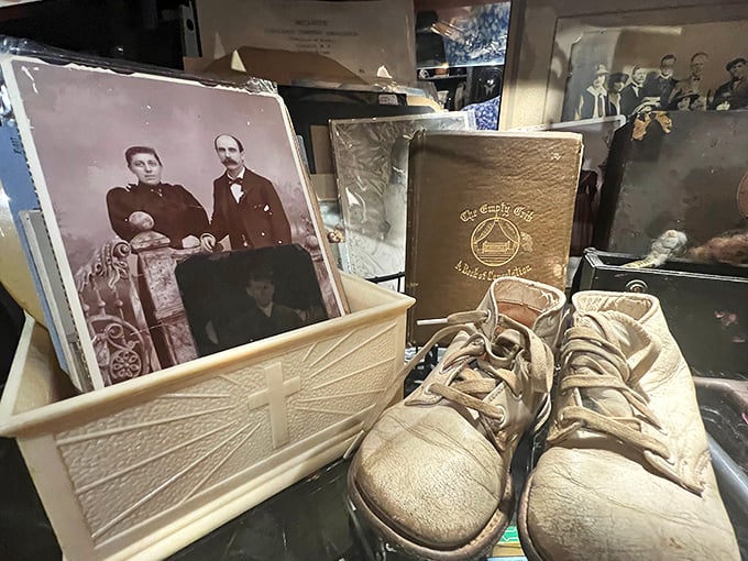 Vintage baby shoes and antique photographs remind visitors that everyday objects become mysterious curiosities with the simple passage of time.