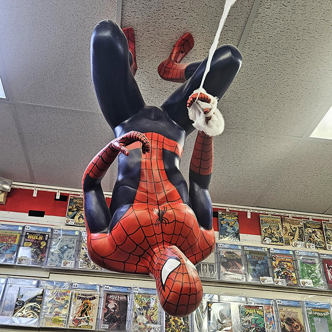 Spider-Man dangles playfully from the ceiling, seemingly caught mid-quip as he watches shoppers below web up their credit cards.