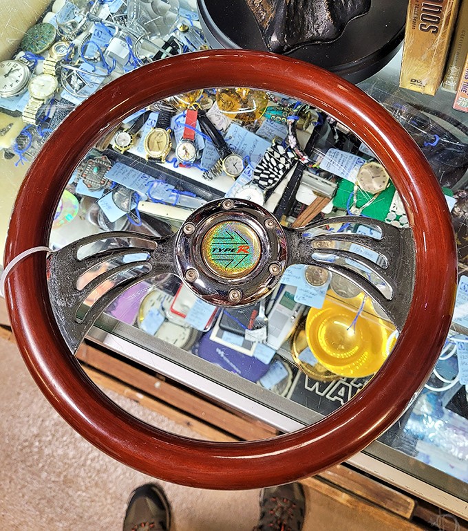 A wooden-rimmed steering wheel that once guided adventures now waits to become wall art in some lucky gearhead's dream garage.