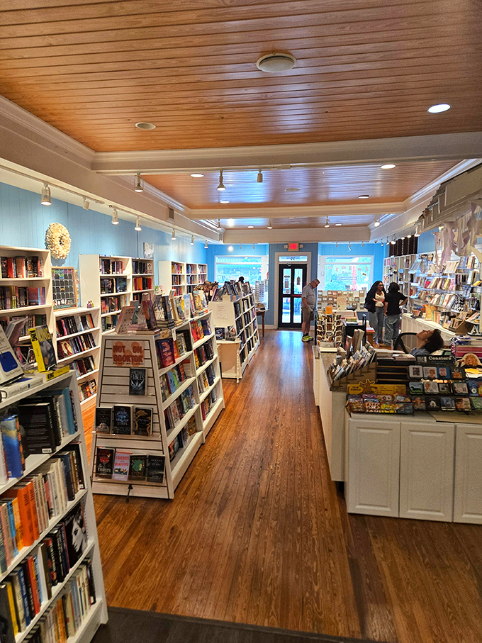 Warm wooden floors and strategic lighting create an inviting path through literary landscapes, guiding browsers from one delightful discovery to the next.