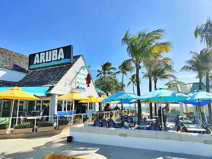 Aruba Beach Cafe serves up ocean views so close you might need to dodge high tide while enjoying their legendary conch fritters.