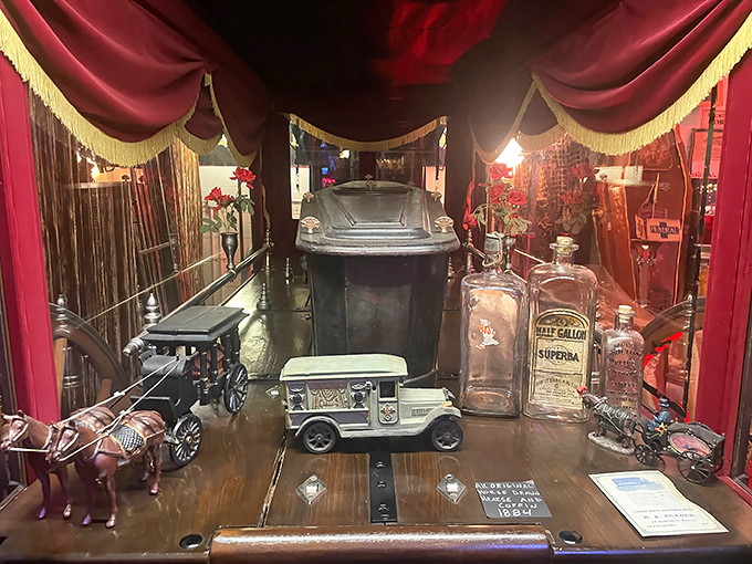 The centerpiece coffin display, surrounded by funeral memorabilia, represents the museum's thoughtful approach to death's historical and cultural significance.