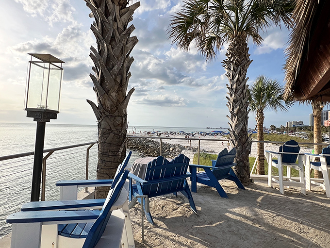 Blue Adirondack chairs facing endless blue water &ndash; the perfect spot to contemplate never returning to real life.