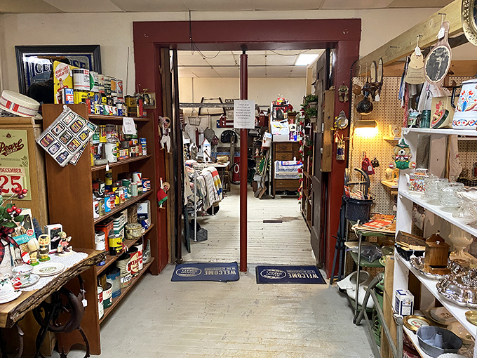 This entryway between rooms serves as a portal between different eras, with vintage signs and collectibles beckoning from both sides of the threshold.