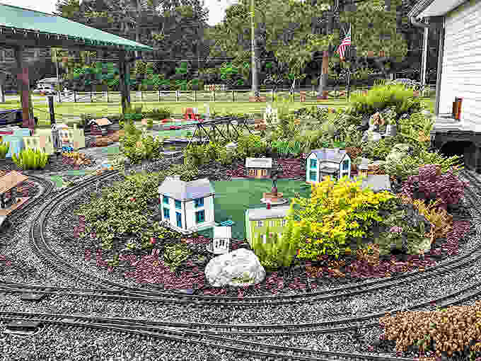 This garden railway combines Florida's lush landscape with miniature buildings, creating a whimsical world where trains wind through living scenery.
