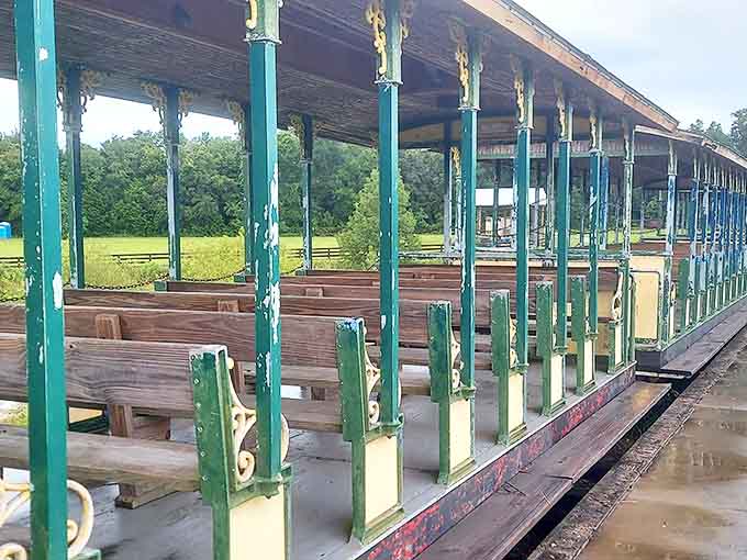 Empty wooden benches await passengers in this vintage train car, where the patina of age adds character rather than detracts from comfort.