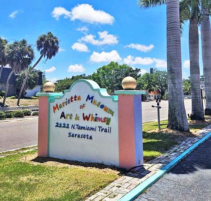 The museum's cheerful signage welcomes visitors with the same enthusiasm that characterizes the entire experience—a pink beacon signaling that normal art appreciation rules do not apply here.