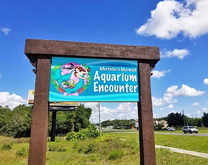 The siren call of adventure beckons from this roadside sign &ndash; promising encounters with mythical creatures just off the highway.