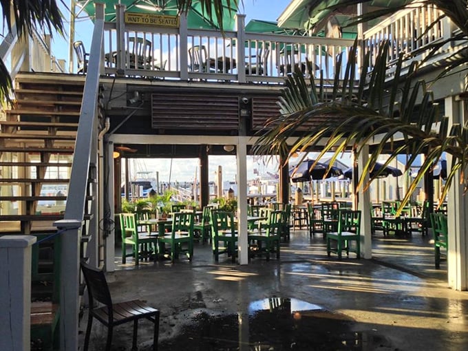 The outdoor seating area hovers between sea and sky, where salt air seasons every bite and the gentle rock of boats provides the soundtrack.