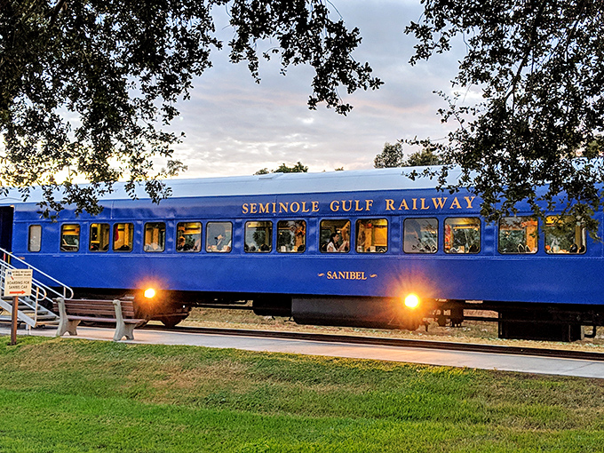 The Seminole Gulf Railway car glows with warm light against the evening sky, promising mysteries and memories for those lucky enough to climb aboard.