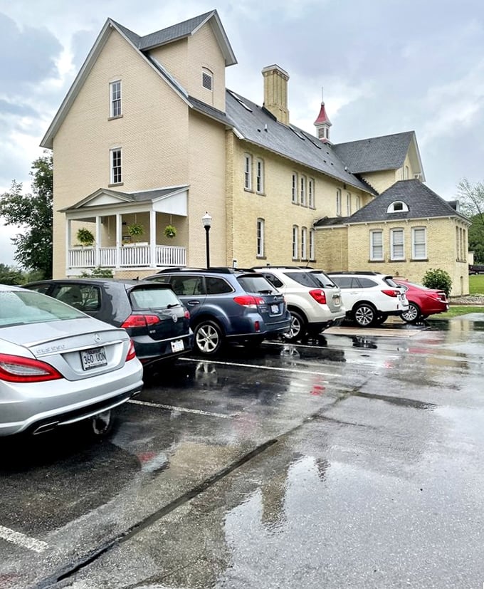 Even on rainy days, visitors flock to these historic buildings – their cars reflecting puddles beneath a sky that's cleared countless times over the century-old structures.