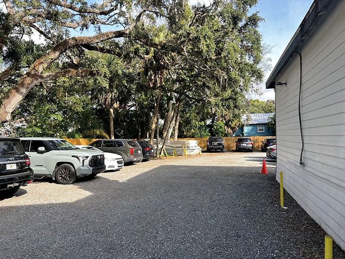 Even the parking area whispers of Florida charm, with oak trees providing natural shade for cars whose owners are about to experience grouper nirvana.