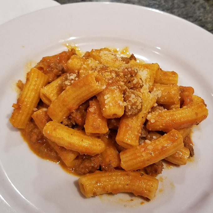 Rigatoni that holds sauce in its ridges and tubes like it was designed by pasta engineers with advanced degrees in deliciousness.