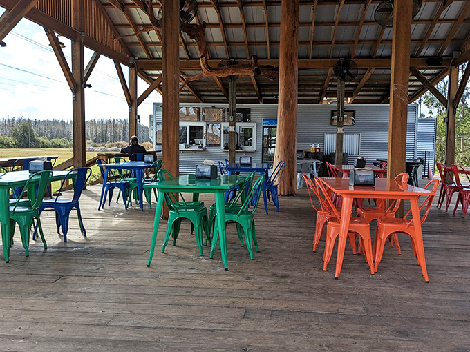 Rainbow-colored chairs invite lingering conversations under the wooden pavilion &ndash; Florida outdoor dining at its most charming.