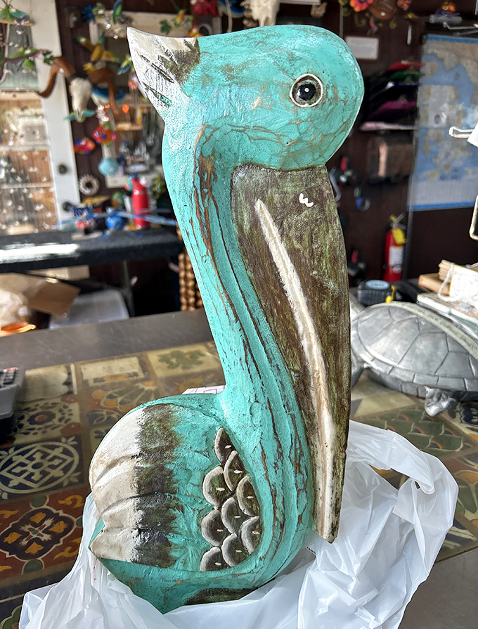 This charming turquoise pelican sculpture captures Florida's coastal spirit with its weathered, artistic finish.