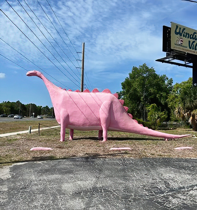 The distinctive profile of Spring Hill's famous pink dinosaur creates an unmistakable silhouette against the Florida sky.