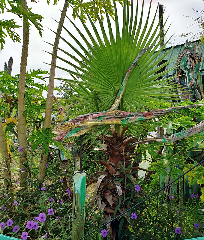 Native Florida plants frame the artistic experience, their natural beauty complementing the human-made creations throughout the gallery.