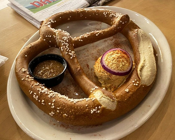 The Riesenbreze – a pretzel so magnificent it deserves its own zip code, shown here with mustard and what appears to be obatzda cheese spread.