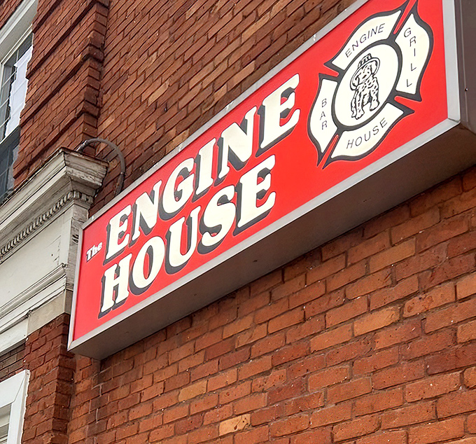The Engine House sign glowing against the brick exterior&mdash;a beacon for hungry travelers seeking authentic local flavor.
