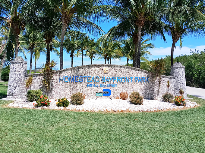 The park's entrance sign stands as a gateway between ordinary life and the extraordinary natural beauty that awaits beyond.