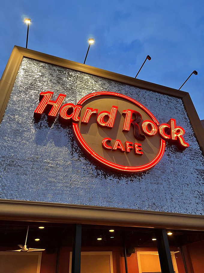 As dusk falls, the Hard Rock sign illuminates like a beacon for hungry music lovers – a glittering promise of good times ahead.