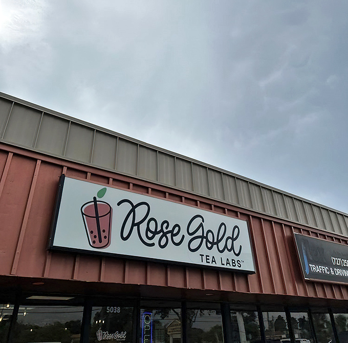 The Rose Gold Tea Labs sign glows like a beacon for bubble tea enthusiasts and pancake pilgrims seeking fluffy nirvana in an unassuming Florida location.