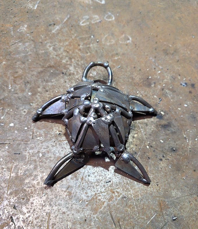 This tiny metal turtle carries the weight of artistic precision on its shell – small enough to hold, detailed enough to marvel at.