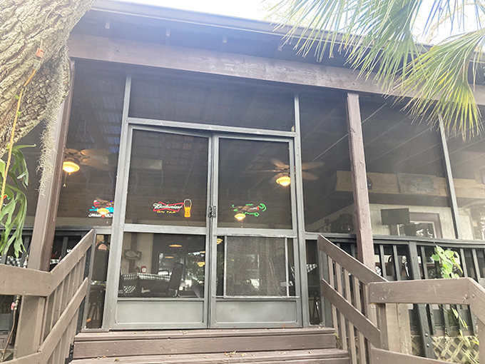 Entrance: The screened porch entrance welcomes hungry visitors into a world where Florida folklore, comfort food, and genuine hospitality create dining magic.