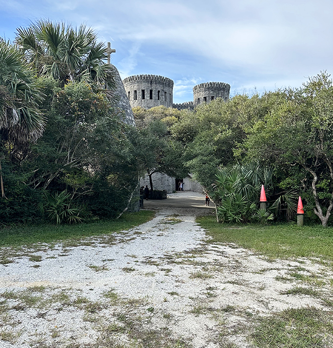 The path to Castle Otttis winds through native vegetation, building anticipation for the medieval wonder waiting just beyond the trees.