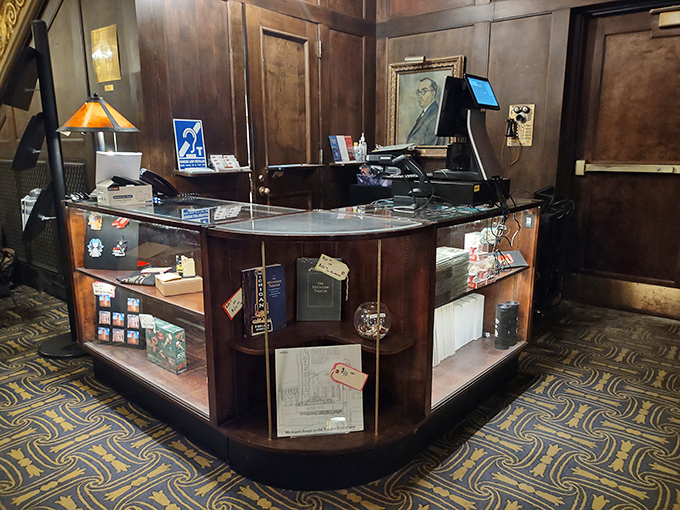 The merchandise counter offers mementos of your visit, surrounded by wood paneling that has witnessed decades of cinematic history.