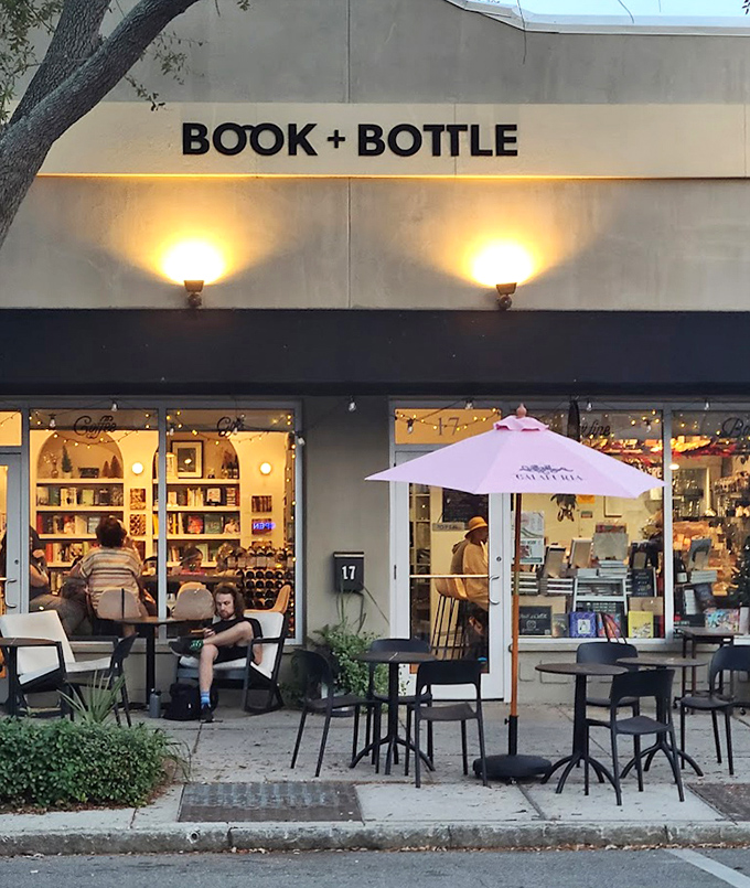 Evening transforms the storefront into a beacon for book lovers and wine enthusiasts, the warm glow promising discoveries that await inside.
