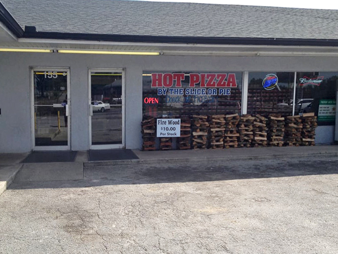 The exterior view with stacked firewood for sale &ndash; because a true general store understands what its community actually needs.