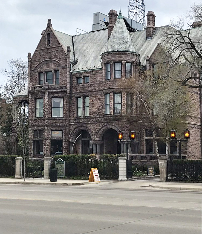 The Whitney's imposing stone exterior and distinctive turret stand proudly on Woodward Avenue, a testament to Detroit's architectural heritage.