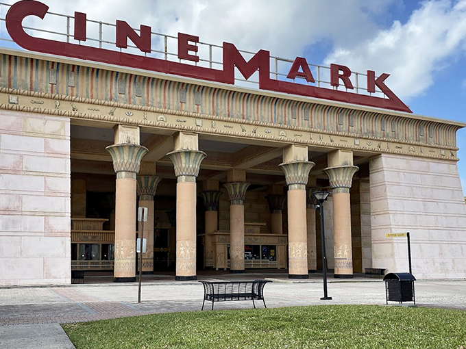 The outdoor entrance beckons with its grand columns and promise of cinematic escape from everyday Florida life.