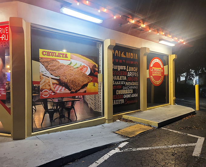 As night falls, the yellow building glows like a beacon for those seeking Colombian hot dog salvation in suburban Florida.