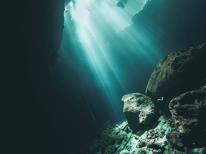 The small museum area displays treasures from the depths alongside hand-drawn maps of underwater passages waiting to be explored.