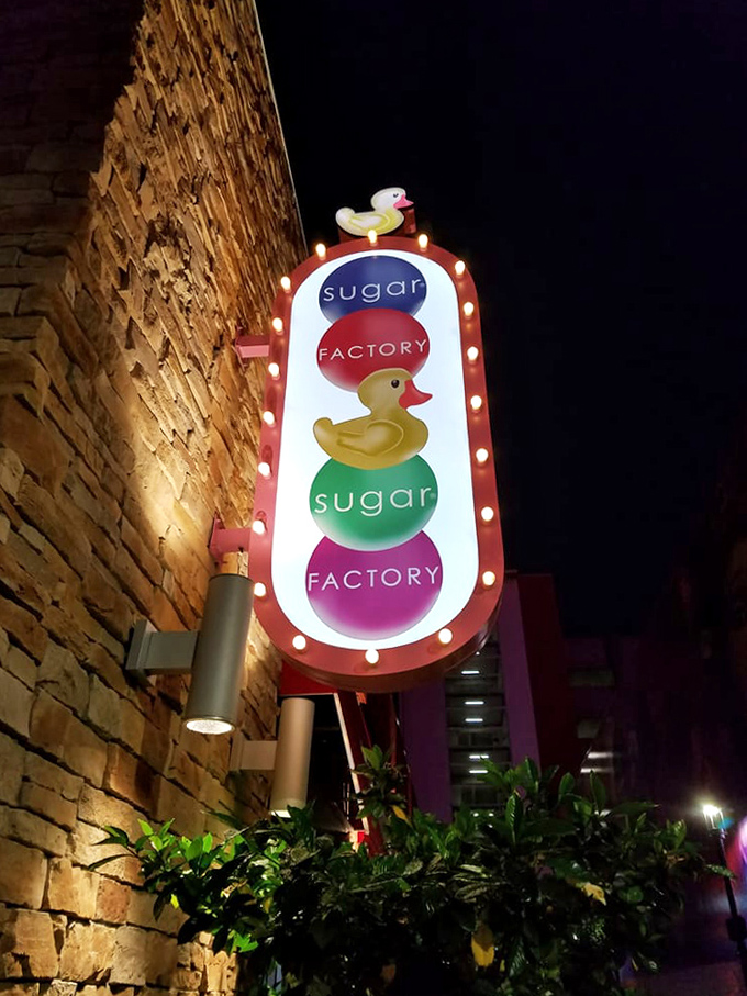 Sugar Factory's illuminated sign glows like a lighthouse guiding sweet-toothed sailors to safe harbor in a sea of restraint.