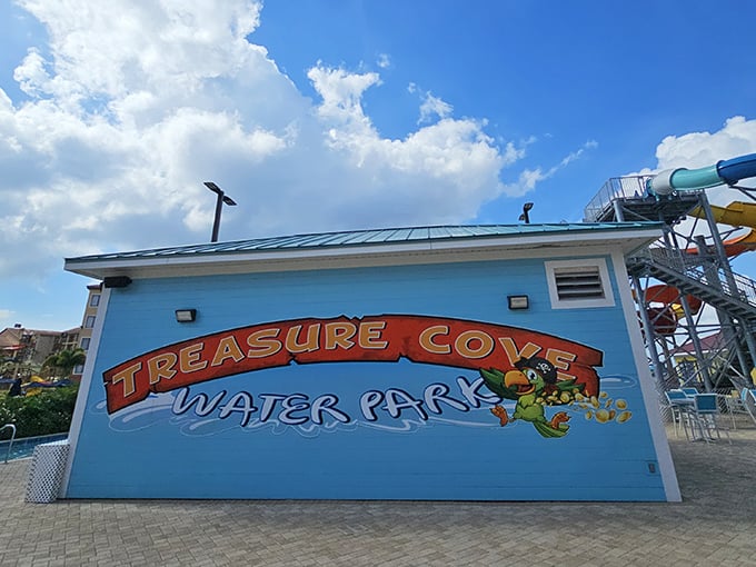 The cheerful "Treasure Cove Water Park" sign promises adventure, standing as a portal between ordinary life and extraordinary water-filled memories.